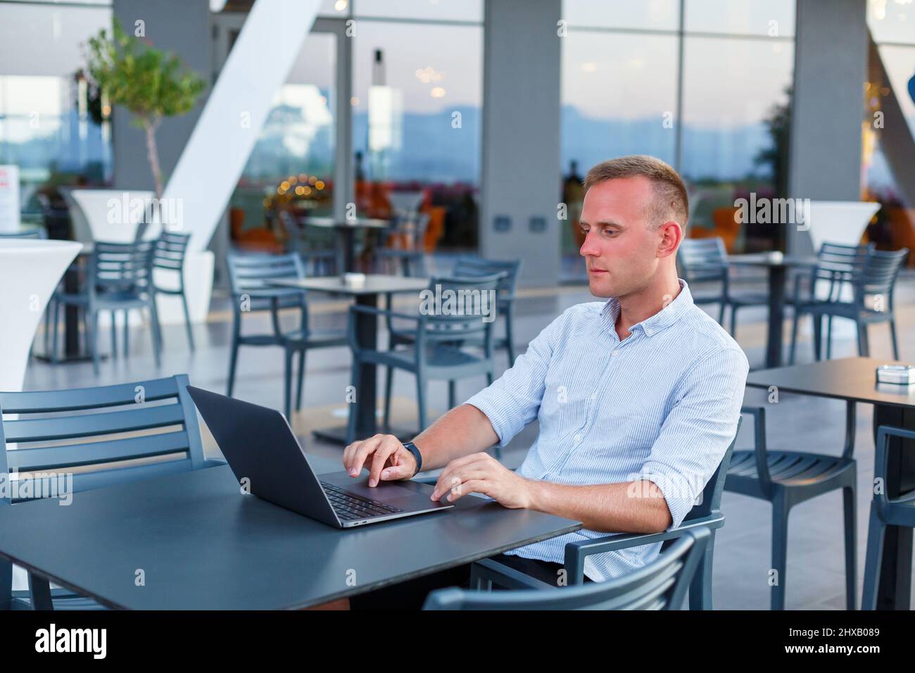 Successful young executive looking while sitting at a table with a ...