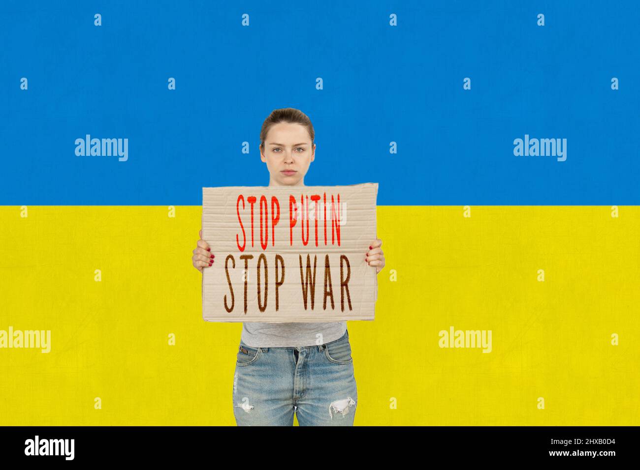 Portrait of upset young girl holding sign with lettering Stop Putin ...