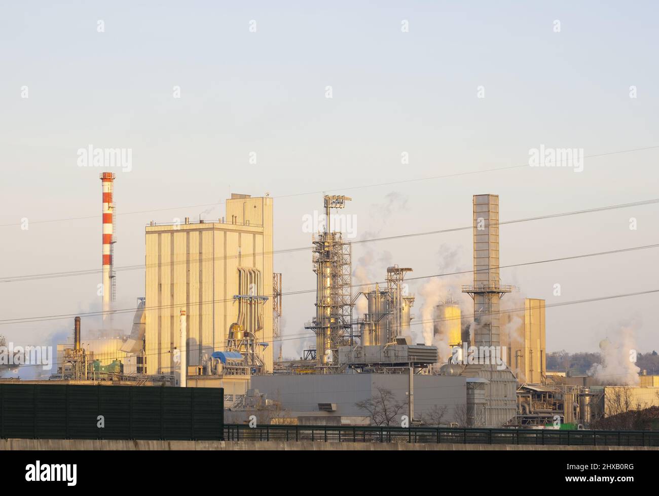 Fumes and pollution in factory chimneys Stock Photo - Alamy