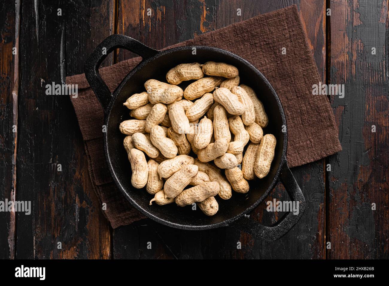Organic peanuts in shell set, on old dark wooden table background, top ...