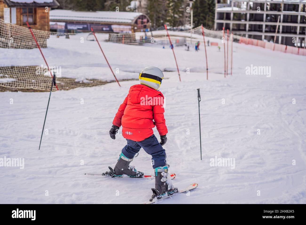 Child skiing in mountains. Active toddler kid with safety helmet ...