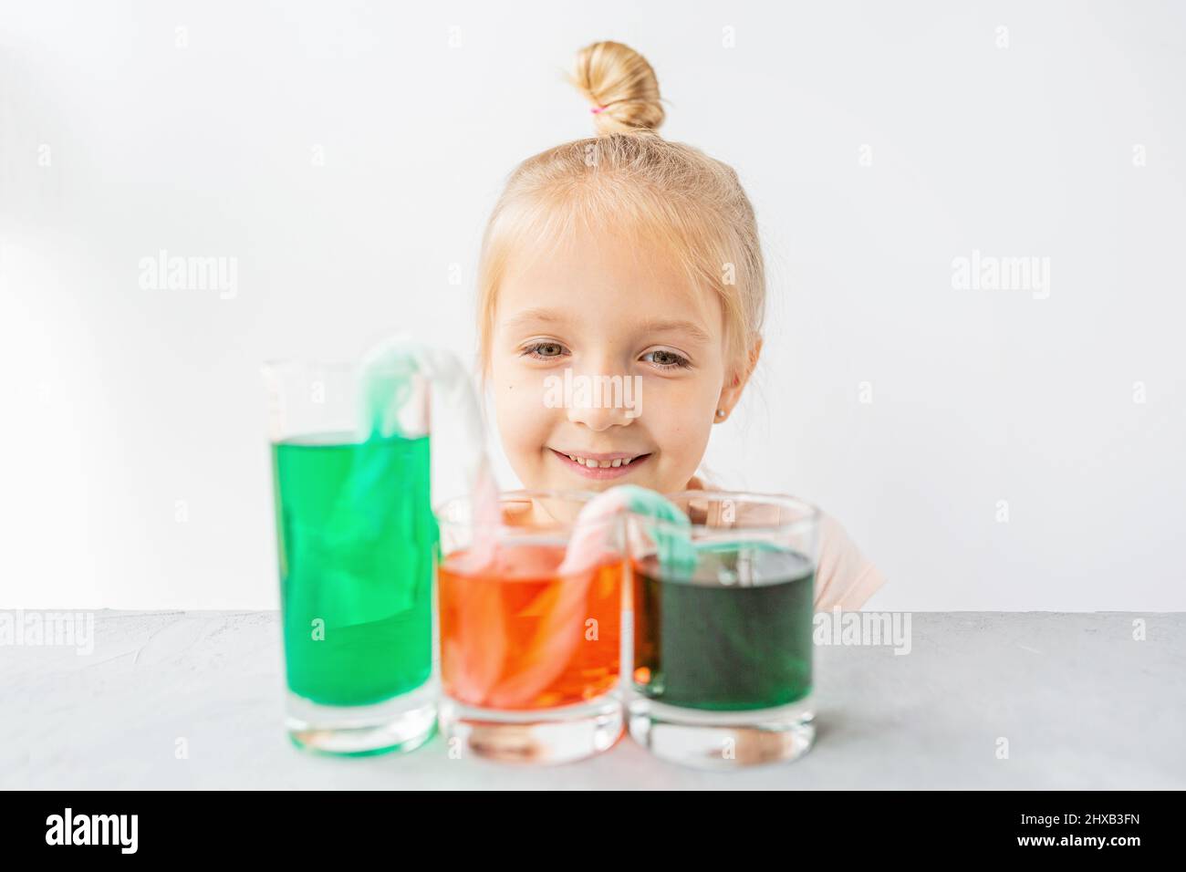cute little girl six years old doing laboratory experiment with ...