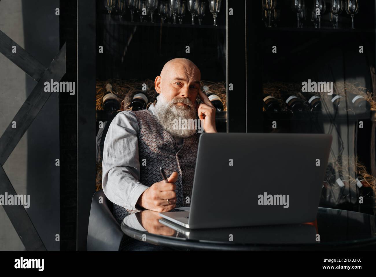 Sitting at a table in front of an open window hi-res stock photography ...