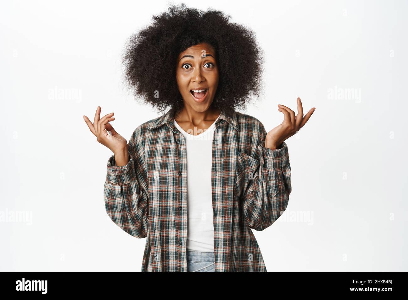 Portrait of surprised and excited woman looking with amazement, spread ...