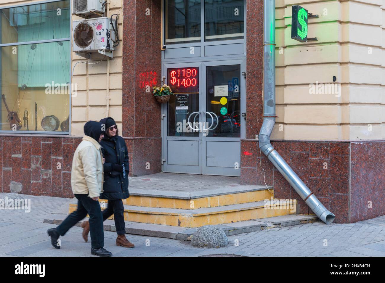 Moscow, Russia. 10th Mar, 2022. People walk past a currency exchange ...
