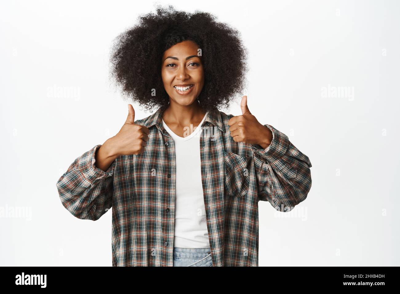 Portrait of millennial african american woman, showing thumbs up, like ...
