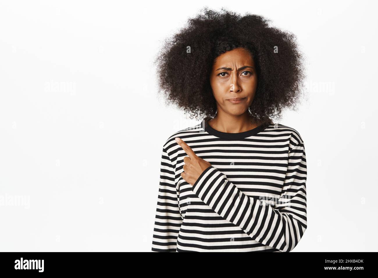 Close up of skeptical african female model frowning, looking displeased ...