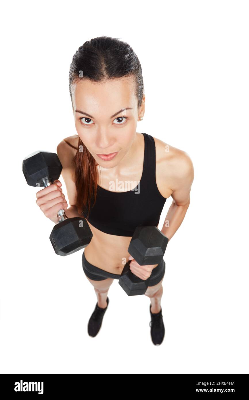 Getting stronger with every lift. Studio shot of a young woman working ...