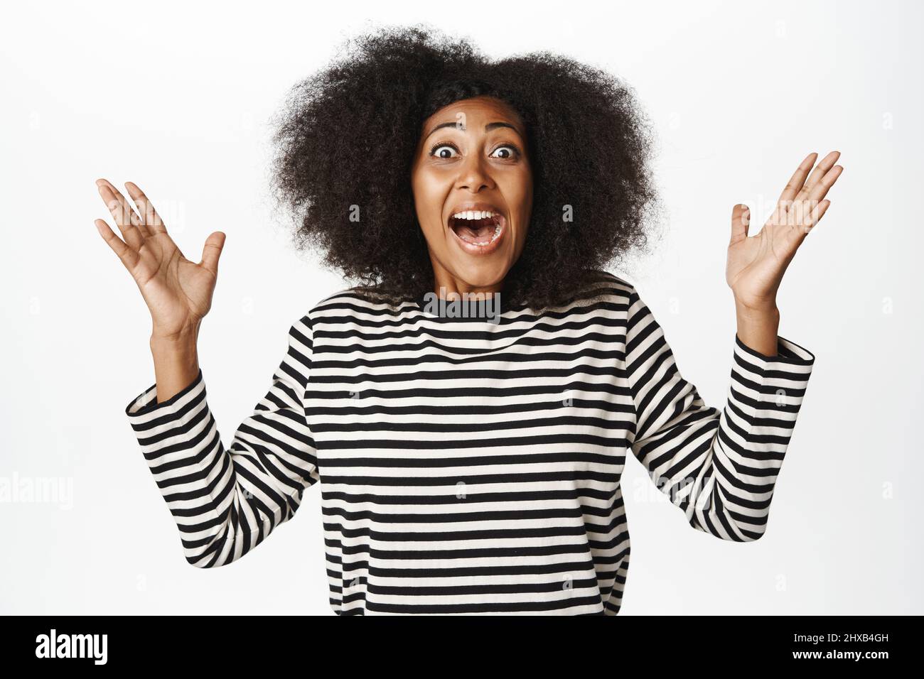 Enthusiastic african american woman celebrating, scream yes, looking ...