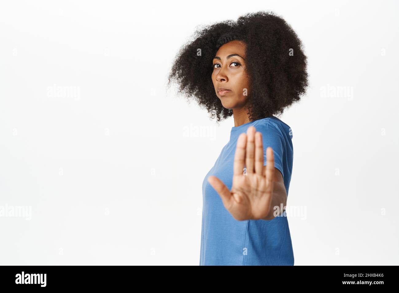 Serious african american woman stretching out one hand, showing taboo ...