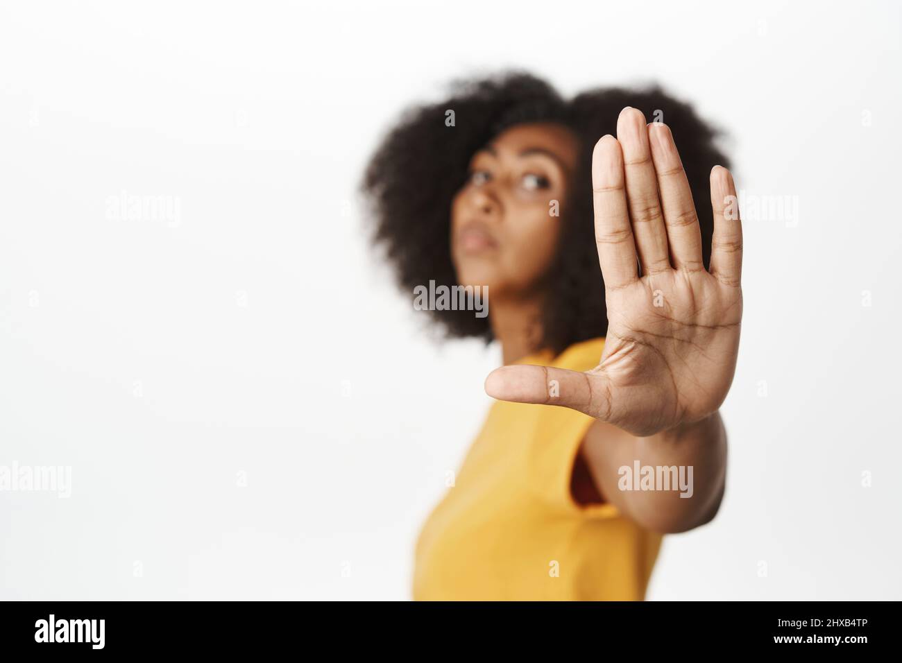 Image of african american serious-looking woman extending hand, stop ...