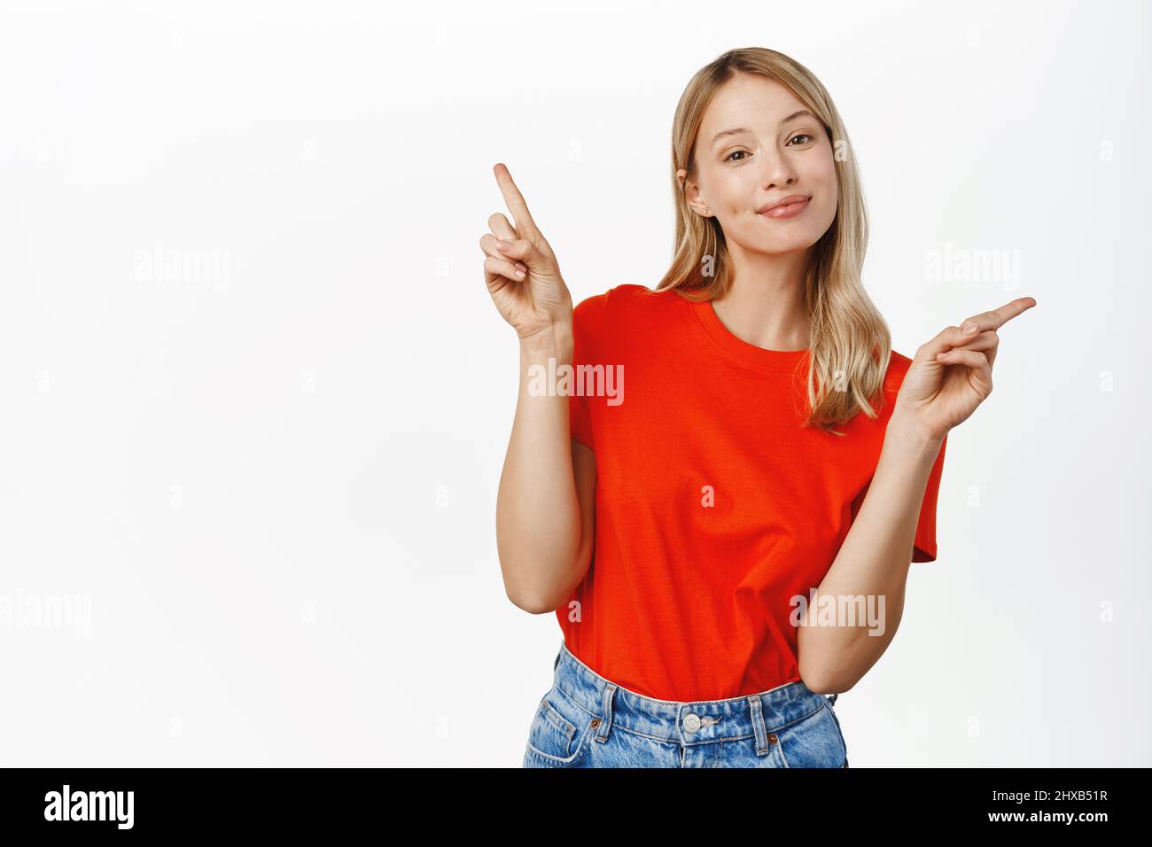 Choice, decision. Cute smiling blond girl pointing sideways, showing ...