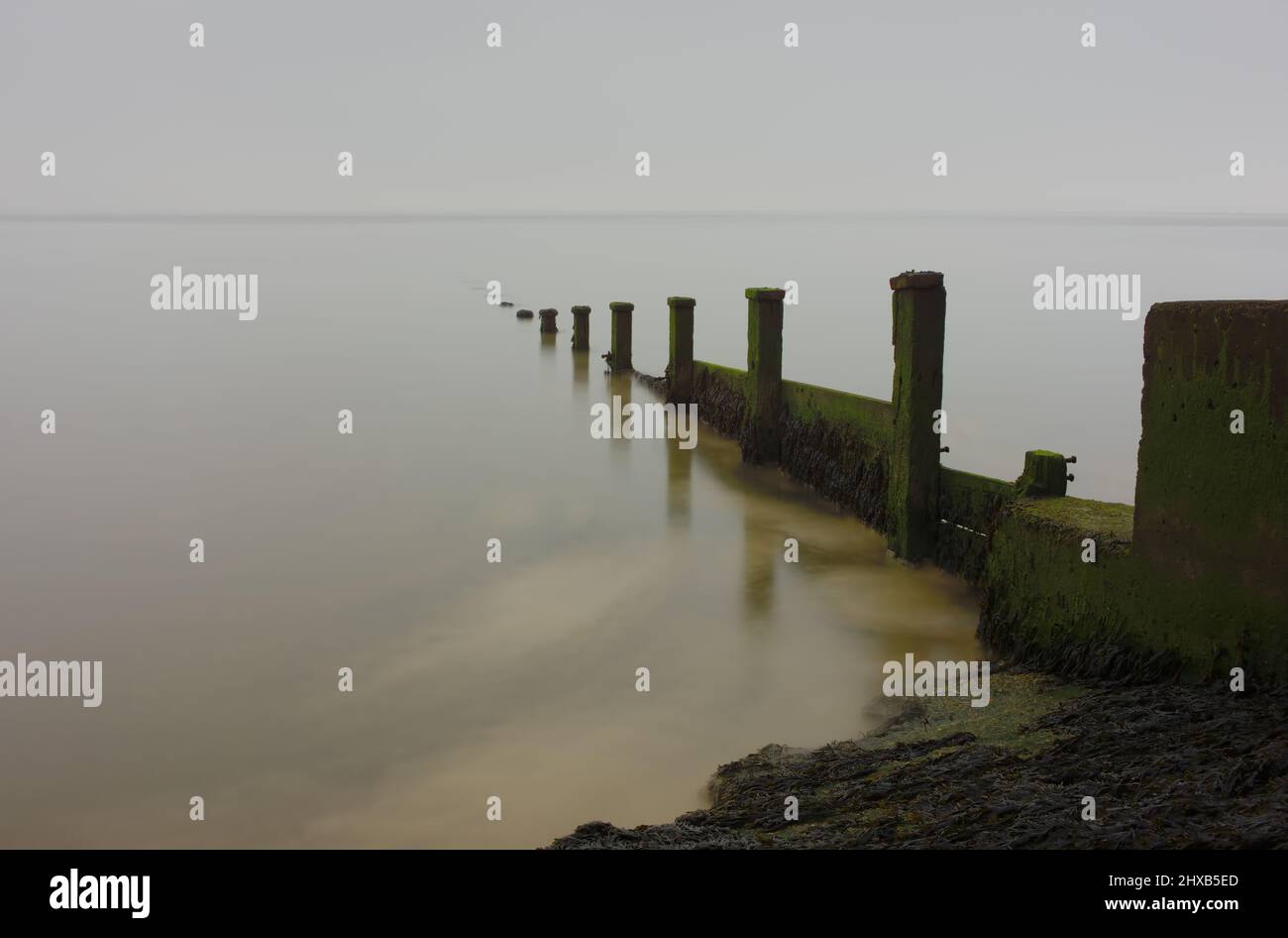 Wooden posts shore sky sunset beach hi-res stock photography and images ...