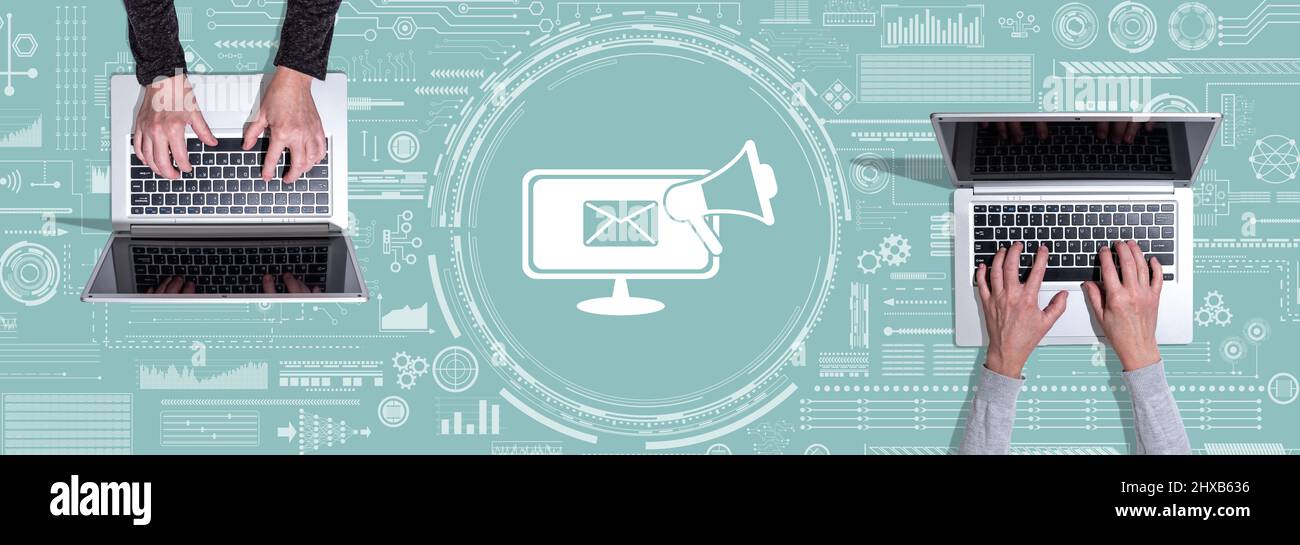 Top view of hands using laptop with symbol of digital marketing concept ...