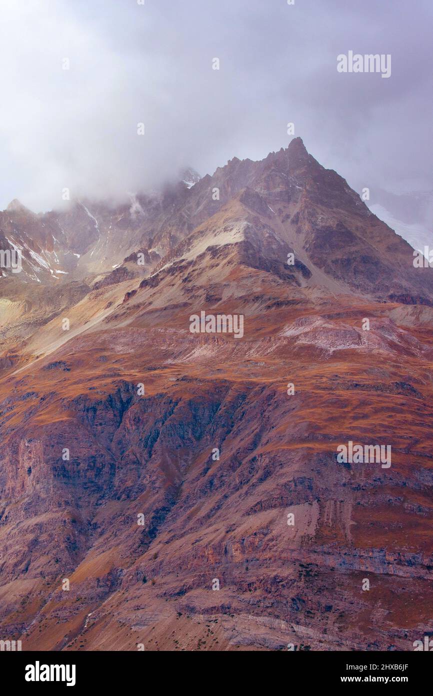 Swiss Alps mountain peaks dramatic sunset view, cloudy sky in ...