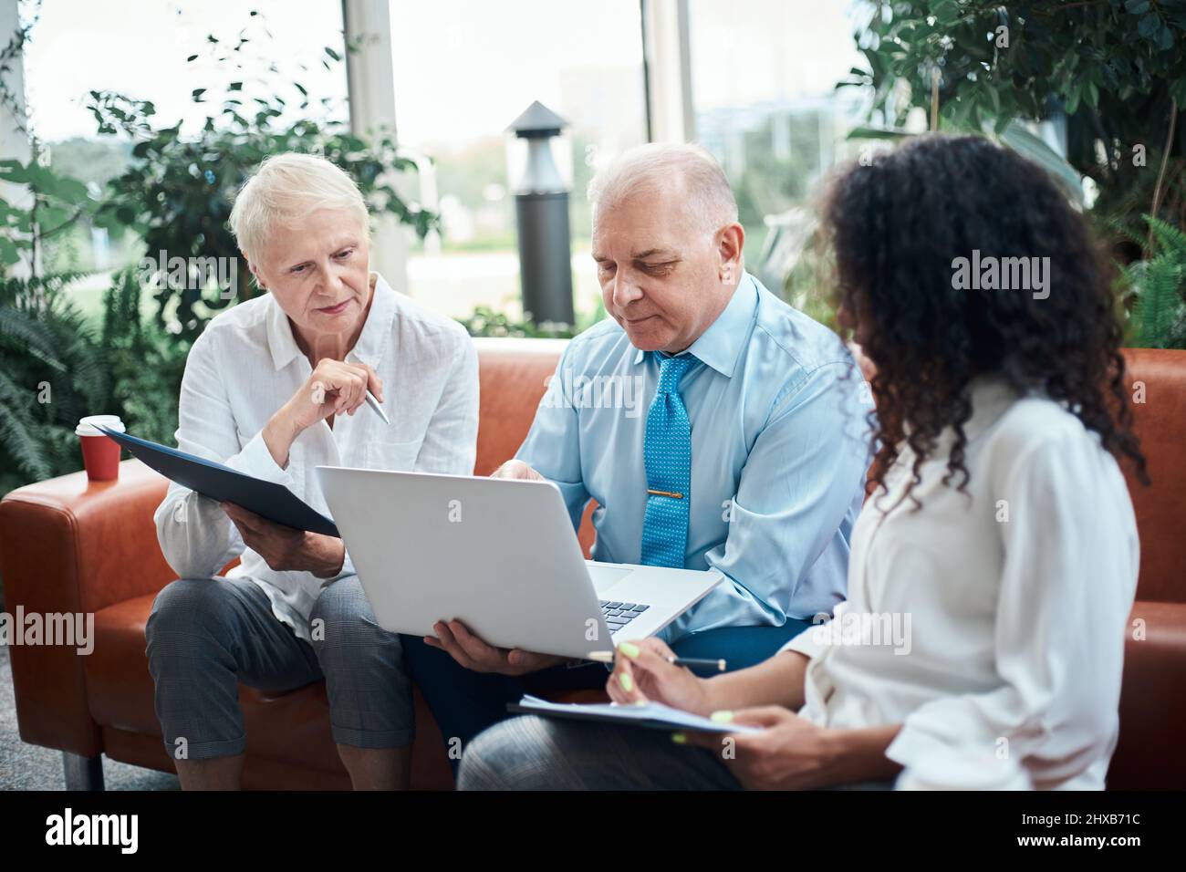 group of business people discussing the points of a new contract Stock ...