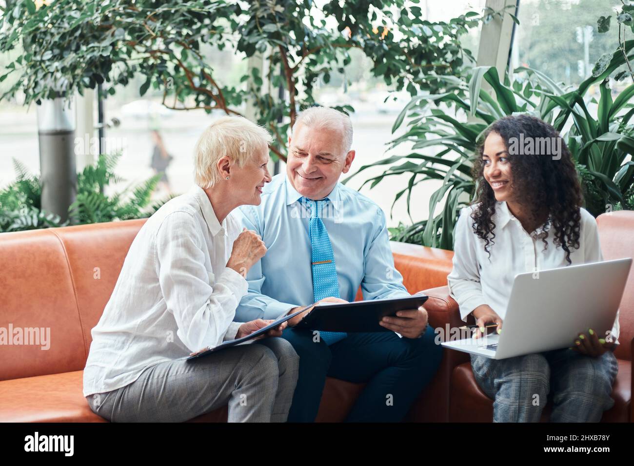 two business women shaking hands before starting a business discussion ...