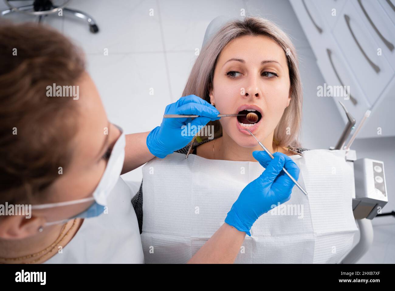 Dentist and patient in the dental office. Caucasian woman at the doctor ...