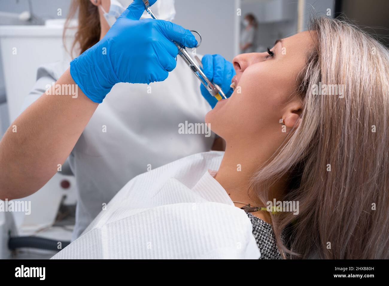close-up portrait caucasian woman at the reception at the dentist. The ...