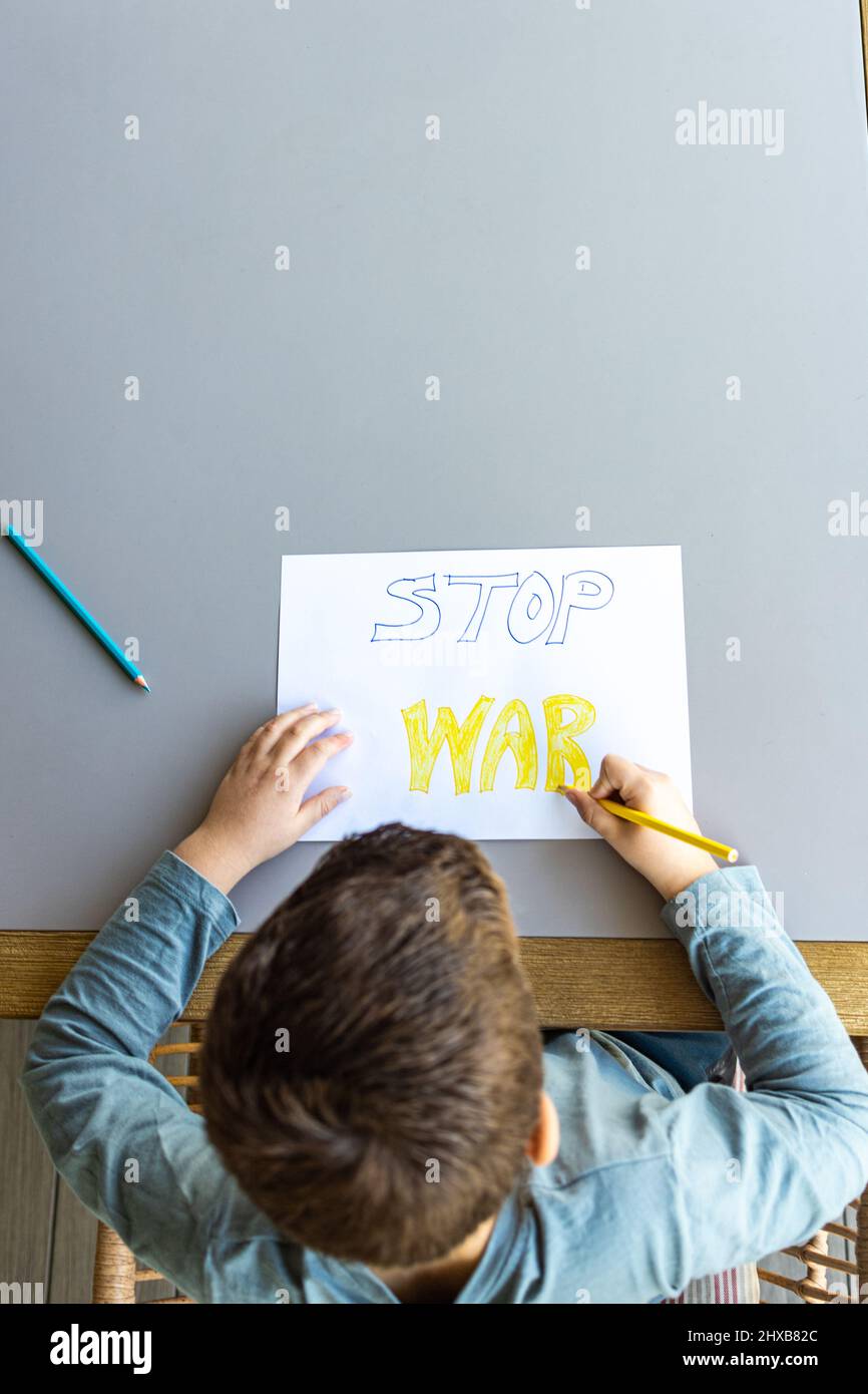 Little kid drawing Stop War on a paper. Ukraine Russia war concept ...
