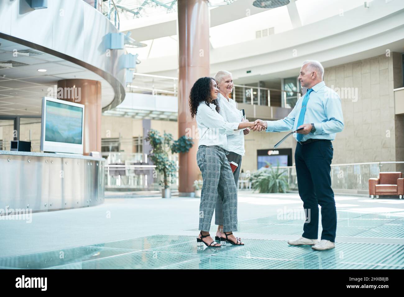 business center visitors meeting each other with a handshake Stock ...