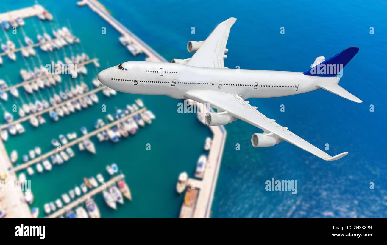 Aerial top down view of an airplane flying over blue sea as a travel ...