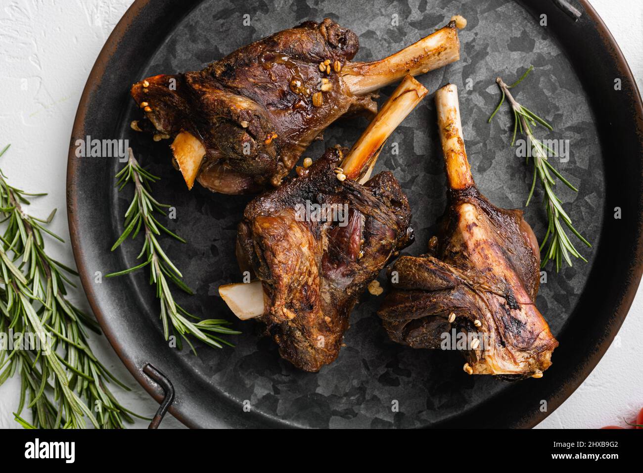 Baked lamb shank meat set, on white stone table background, top view ...