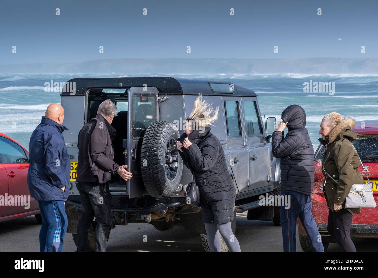 People in a car park in storm force wind brought by Storm Eunice as it ...