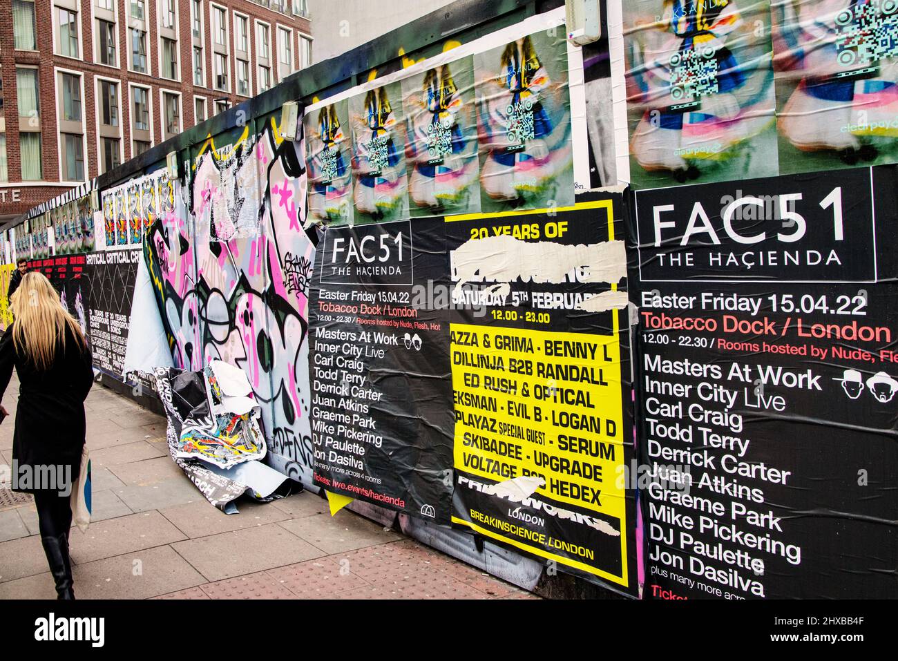 Large number of posters on wall in street in Whitechapel in London ...