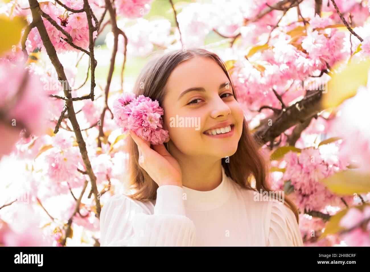 glad teen girl at sakura flower bloom in spring Stock Photo - Alamy