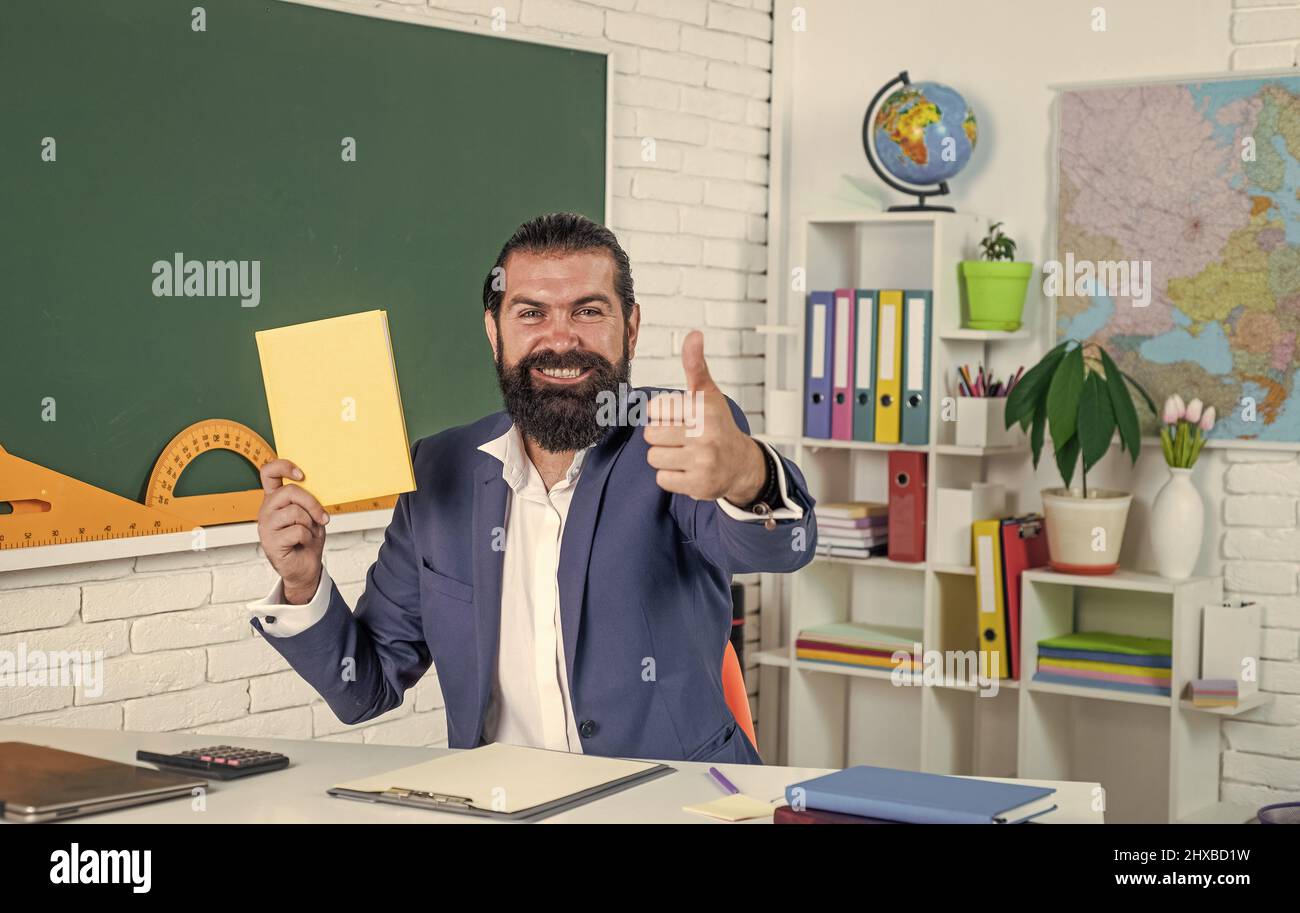 Portrait Of Male Elementary School Teacher with thumb up In Classroom ...
