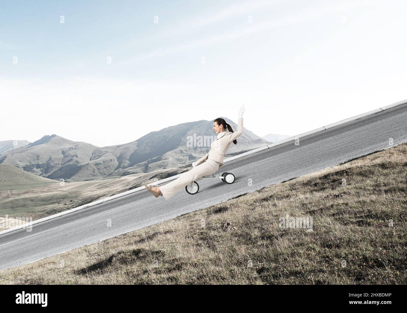 Beautiful happy woman riding downhill Stock Photo - Alamy