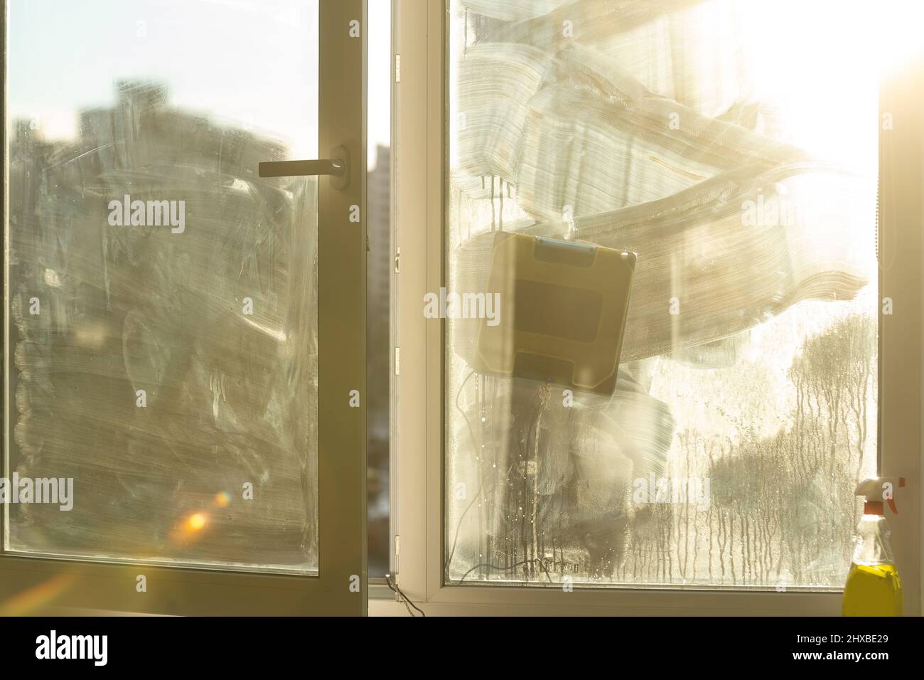 Window with very dirty and dusty glass in daylight. cleaning robot ...