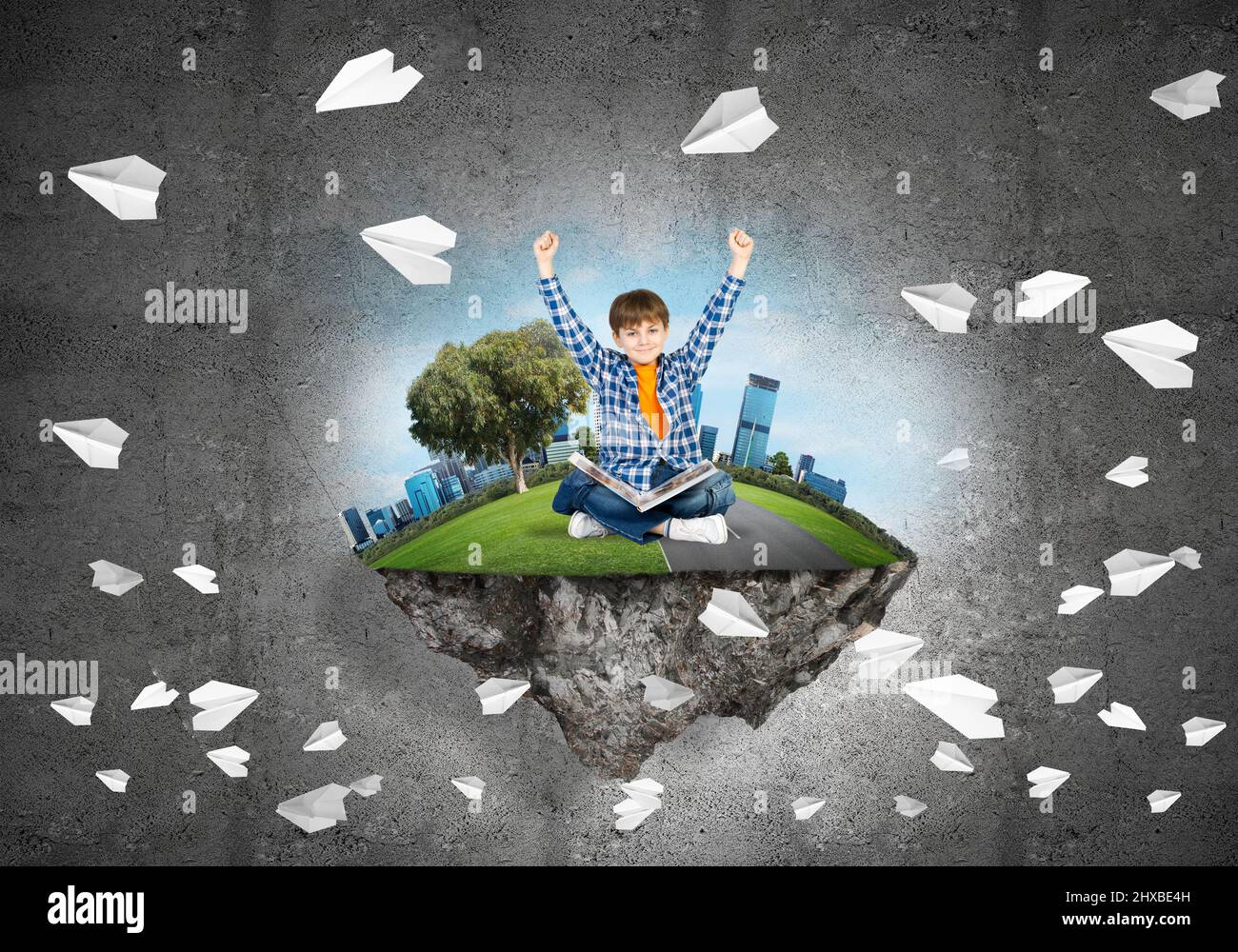 Cute boy of school age with book exploring this great world Stock Photo ...