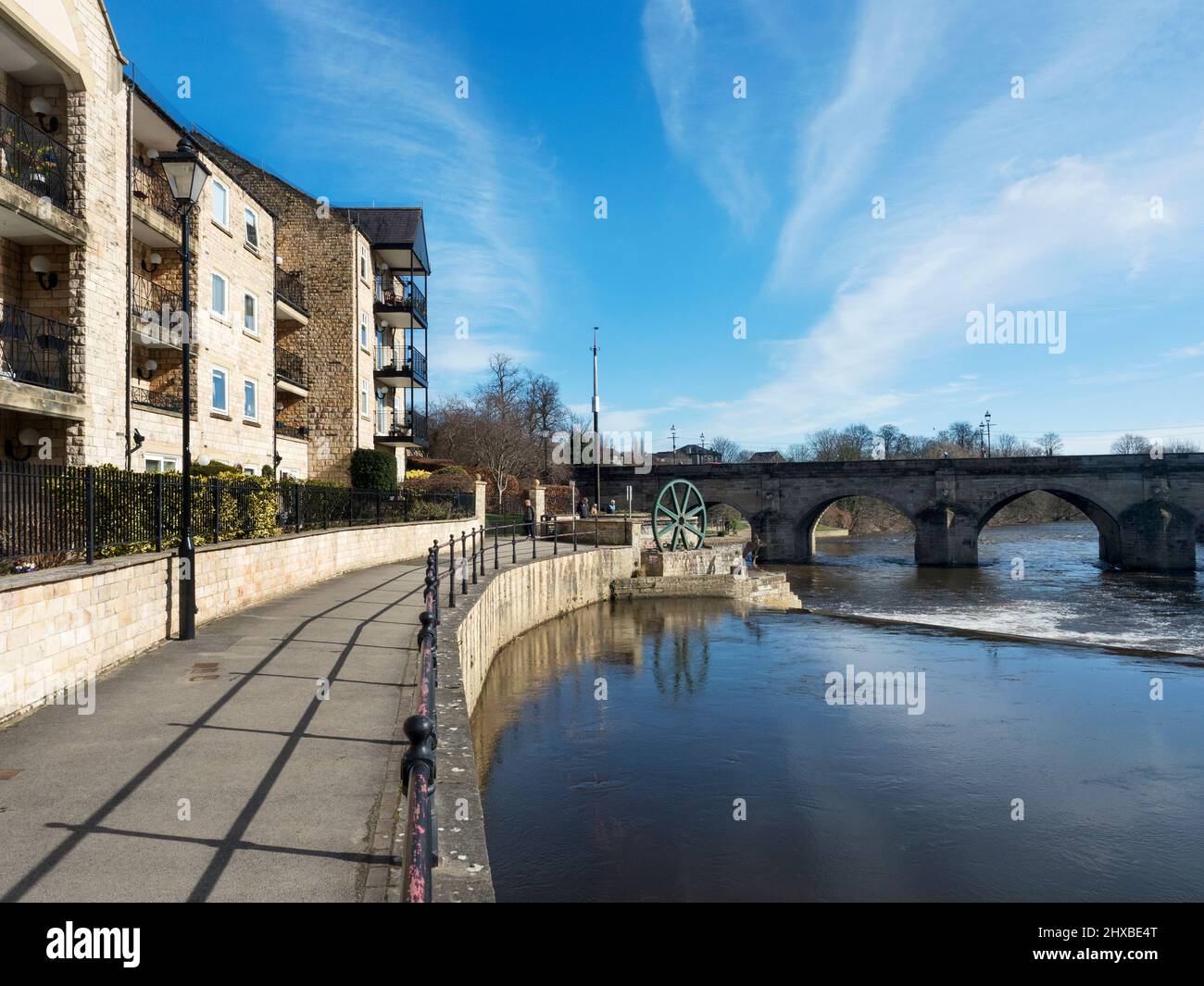 Riverside path above the weir and bridge over the River Wharfe at ...