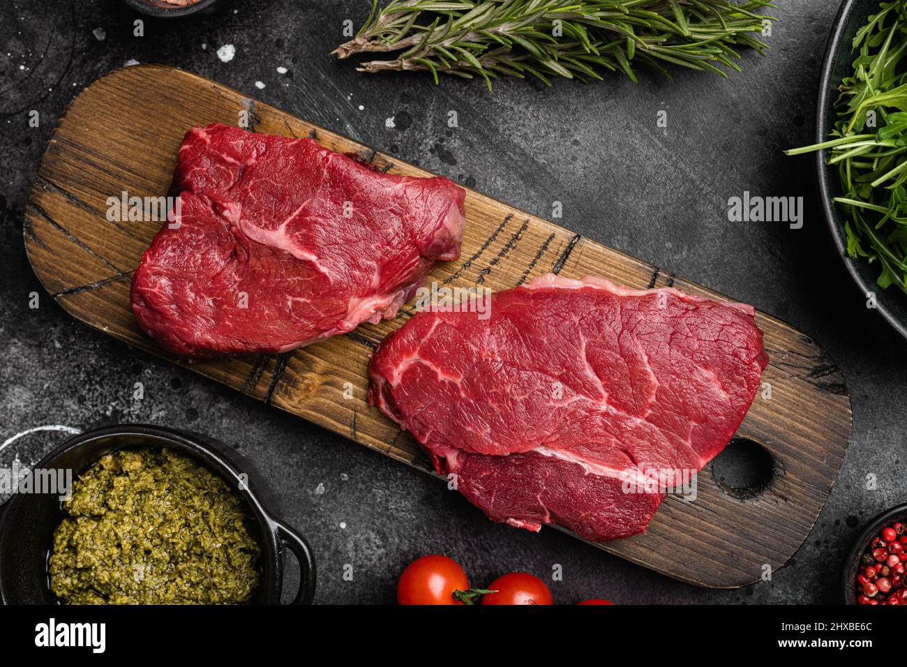 Raw seasoned rump steaks beef meat set, on black dark stone table ...
