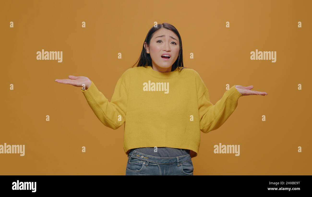 Unsure person raising shoulders and not knowing answer, showing doubt ...