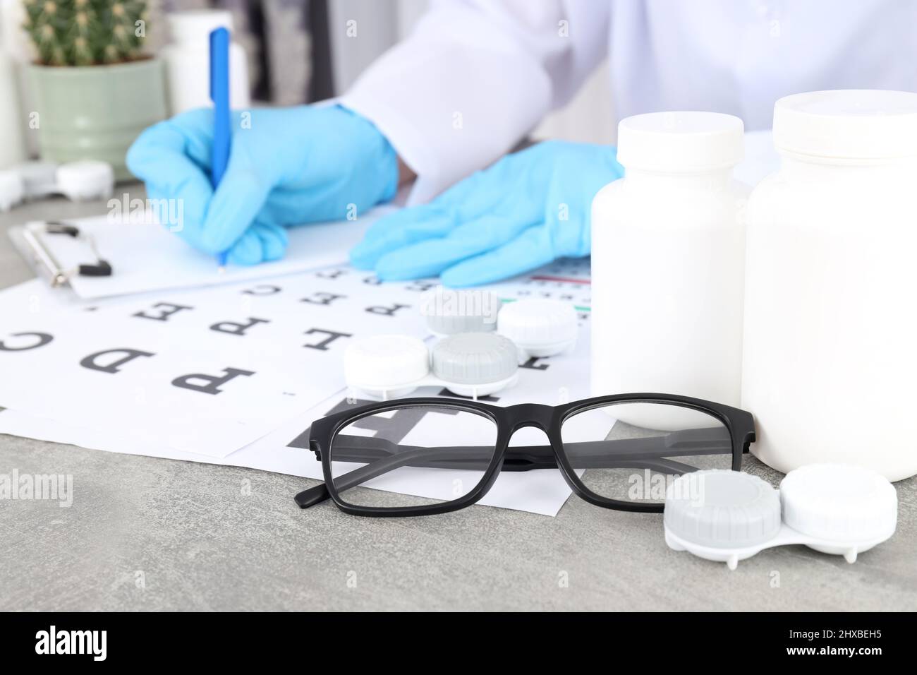 Female doctor write prescription into clipboard on table Stock Photo ...