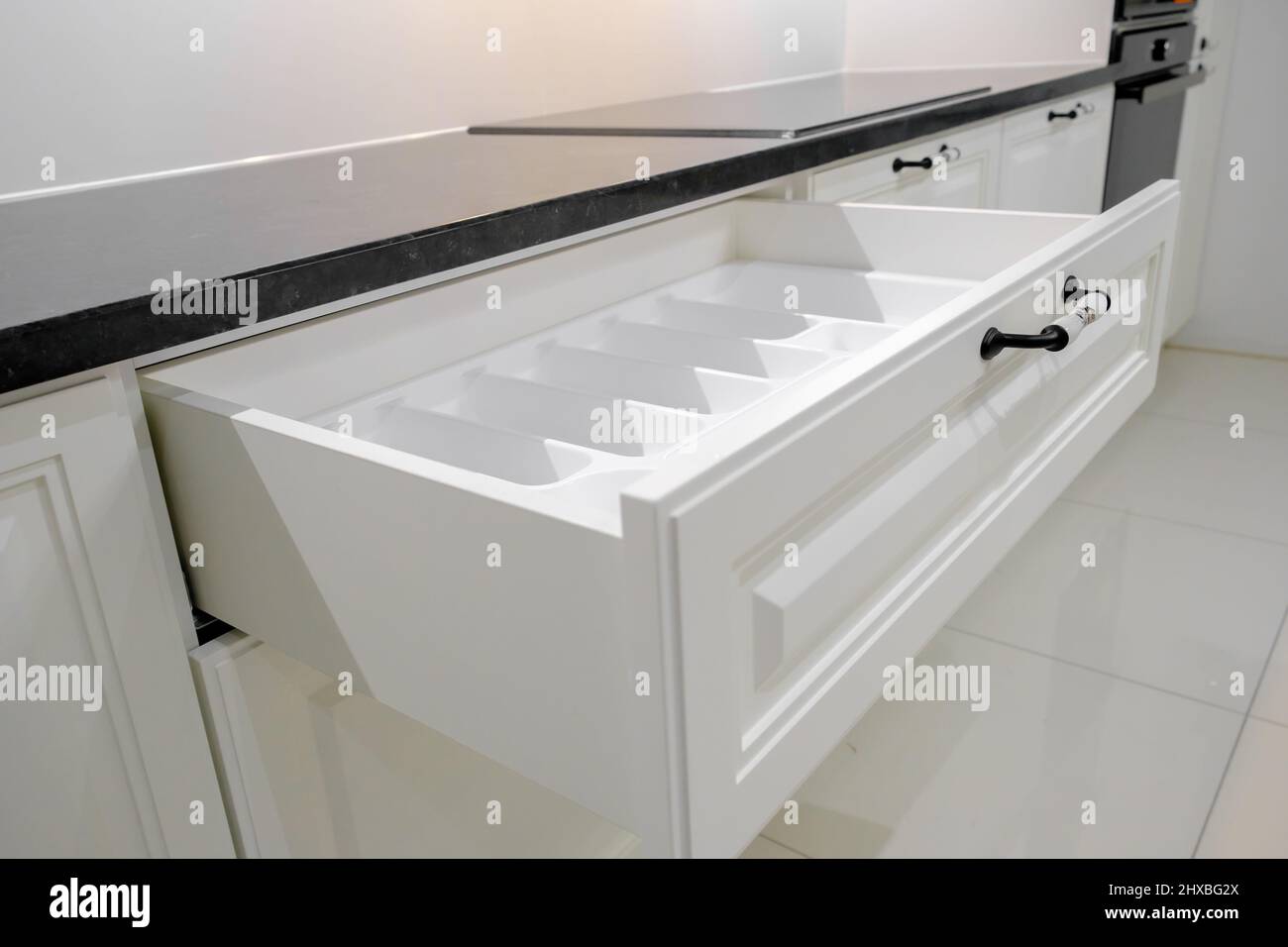 Side view modern and elegant kitchen with white drawers, open kitchen ...