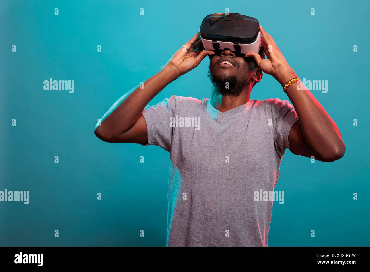 African american person using vr goggles and looking up to see 3d ...