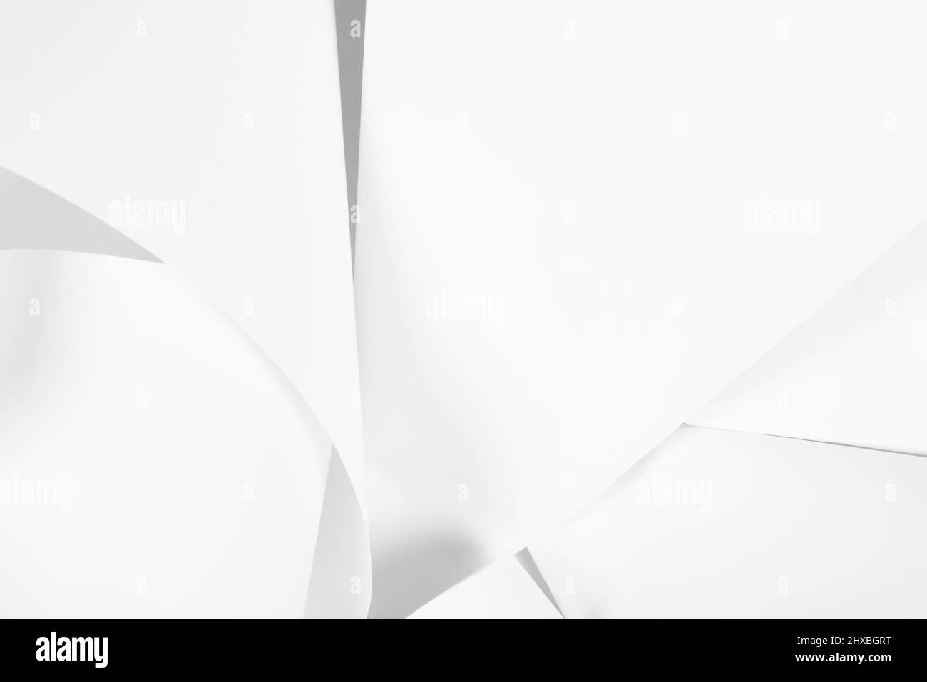 White sheets of office paper are twisted and scattered. Paper white ...