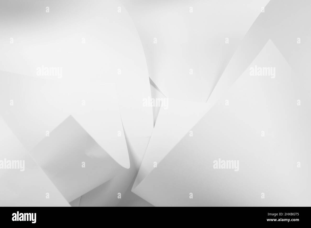 White sheets of office paper are twisted and scattered. Paper white ...