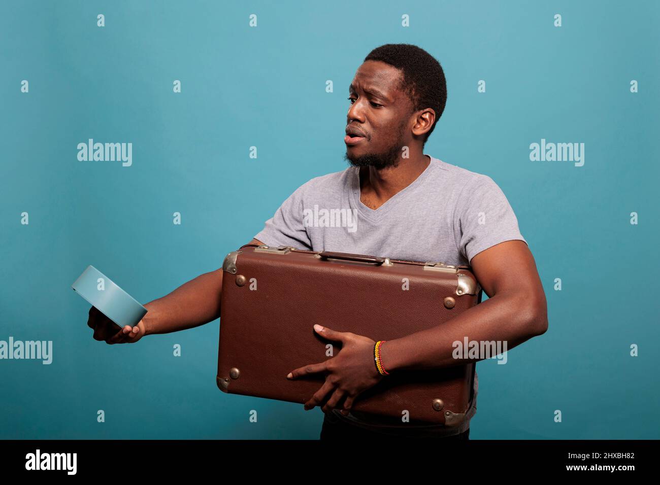 Unhappy person rushing with briefcase to leave for vacation, checking ...