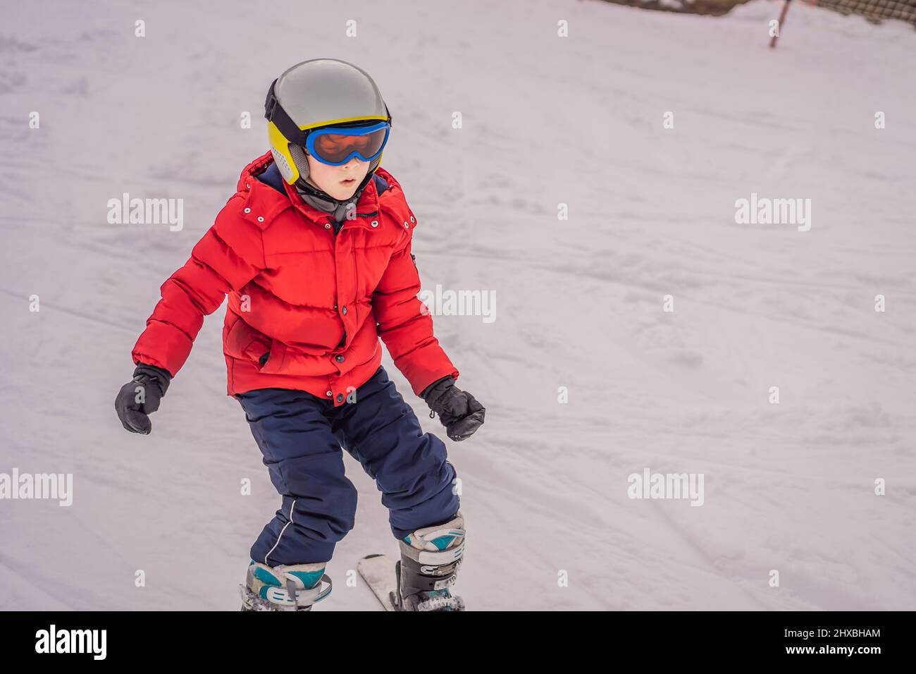 Child skiing in mountains. Active toddler kid with safety helmet ...