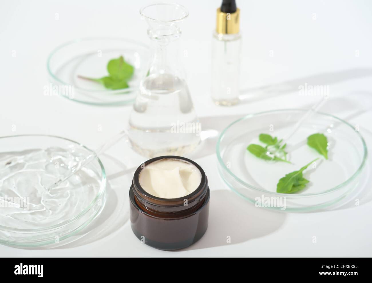 Vegan cosmetic cream and laboratory petri dishes on a lab table and ...