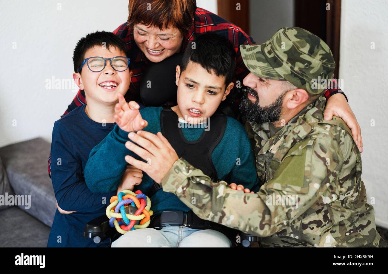 Happy soldier man hugging his family after returning from military ...