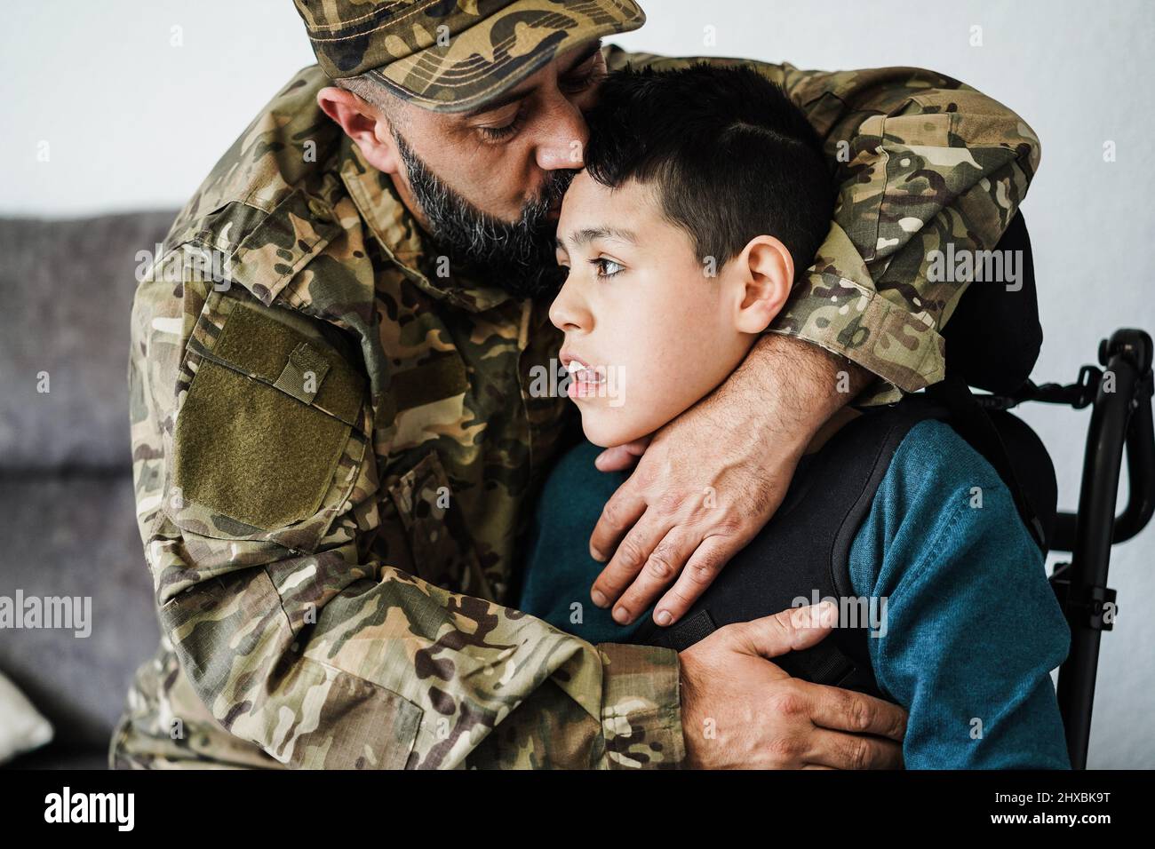 Military soldier hugging his son with disability at home - Family ...