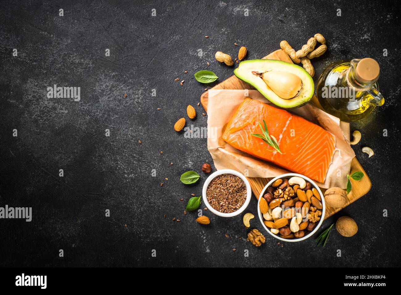 Healthy fats products at black background Stock Photo - Alamy