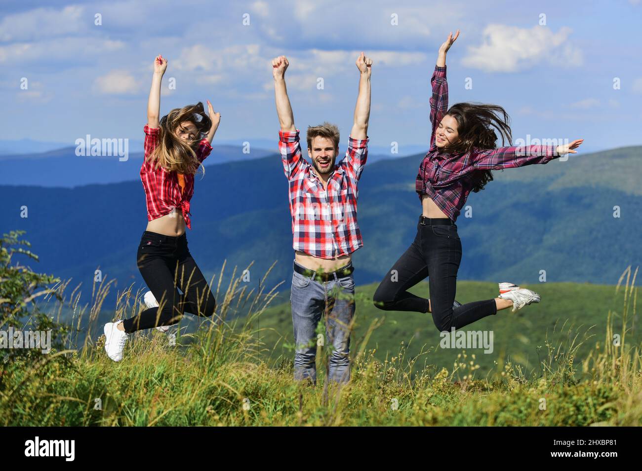 Happy weekend. Reached top. Happy cheerful friends celebrate reaching ...