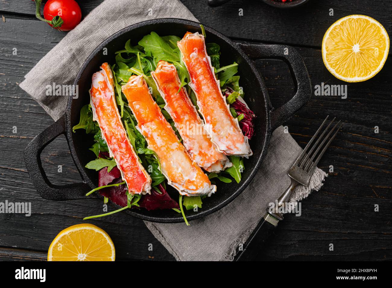 Cooked crab legs set, on black wooden table background, top view flat ...